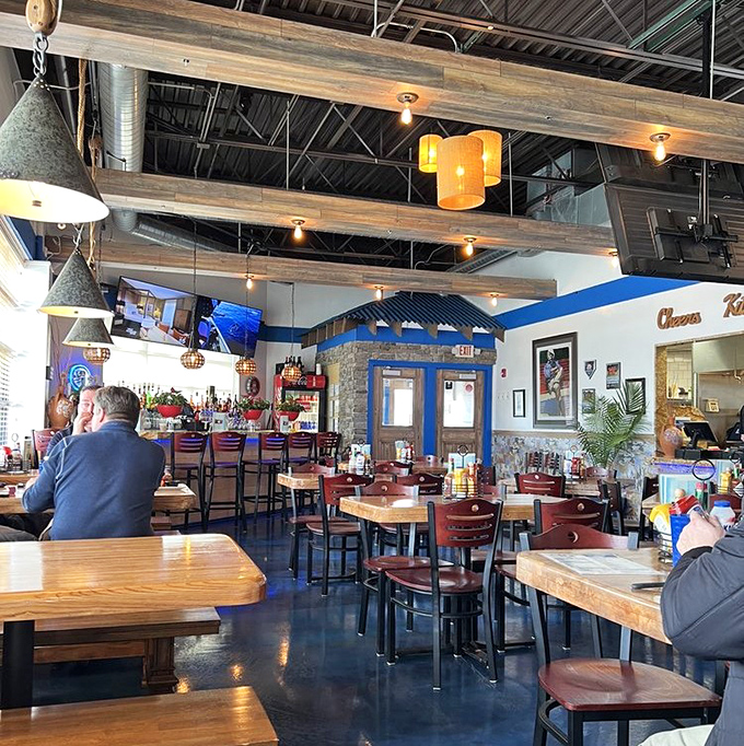Exposed beams, pendant lights, and that signature blue trim&mdash;dining here feels like someone transported a slice of Santorini to the Midwest.