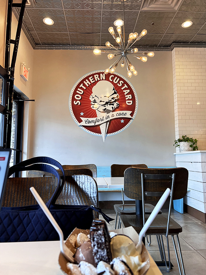 That starburst light fixture illuminating their vintage-inspired logo creates the perfect backdrop for custard contemplation. Mid-century modern meets timeless flavor.