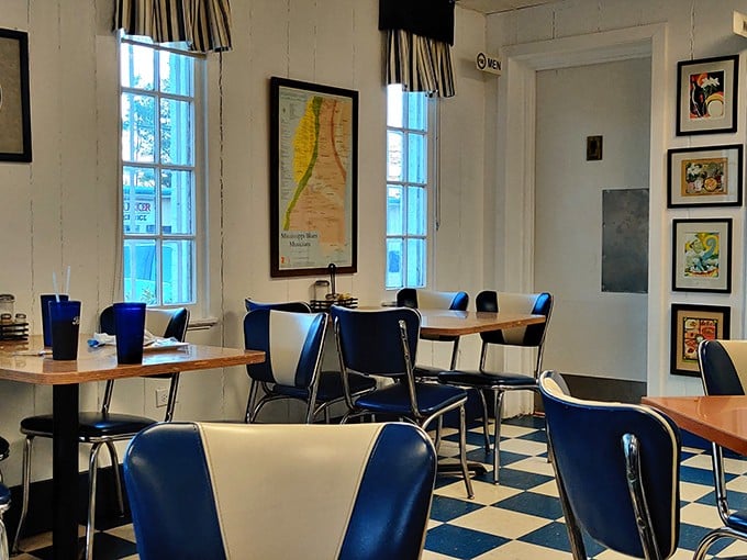 The dining room's blue and white theme extends to every detail, from the striped curtains to the map of Mississippi watching over hungry patrons.