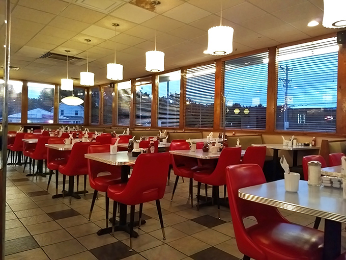 Red chairs await their next occupants like loyal soldiers, ready to support another round of breakfast enthusiasts.