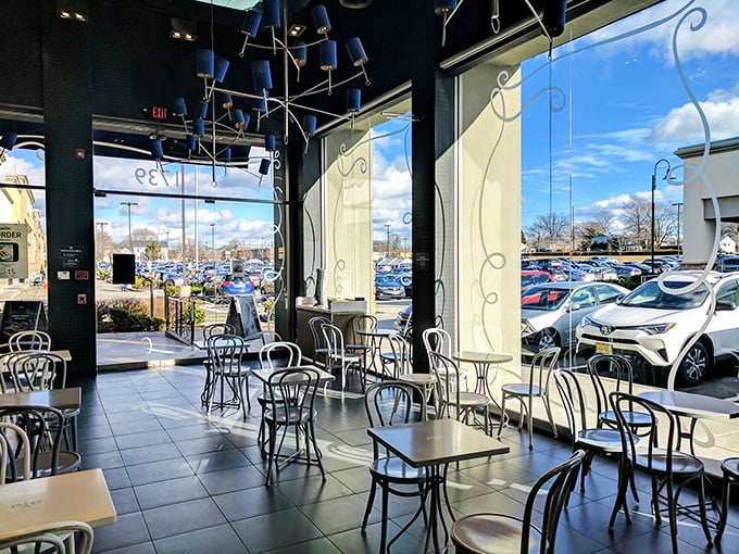 The café's airy interior offers the perfect backdrop for both serious coffee contemplation and the inevitable "just one more bite" of whatever you've chosen from the display case.