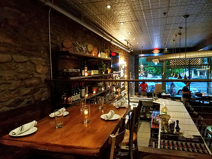 Dining beneath ornate tin ceilings with stone walls that whisper tales of historic Lawrence. Rustic elegance that enhances every bite.