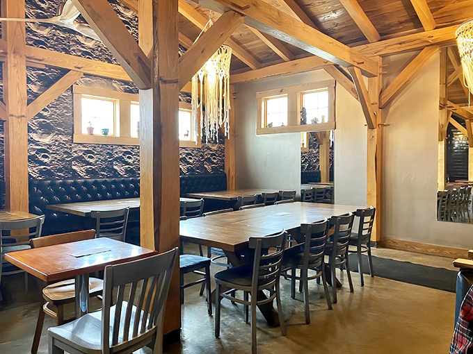 Tufted blue banquettes and wooden beams create dining nooks that feel both intimate and social. Like dining in a stylish friend's renovated barn.