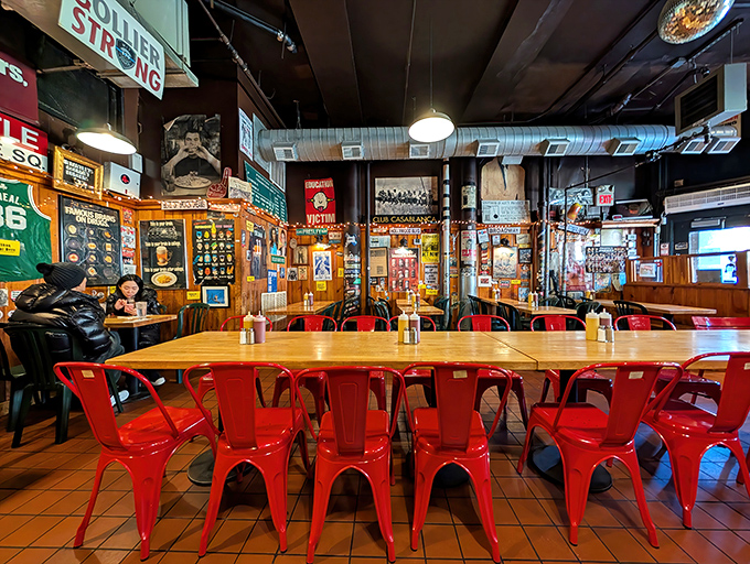 Red chairs pop against wooden tables in this temple of burger worship. Every inch tells a story, from the memorabilia-covered walls to the well-worn floor tiles.