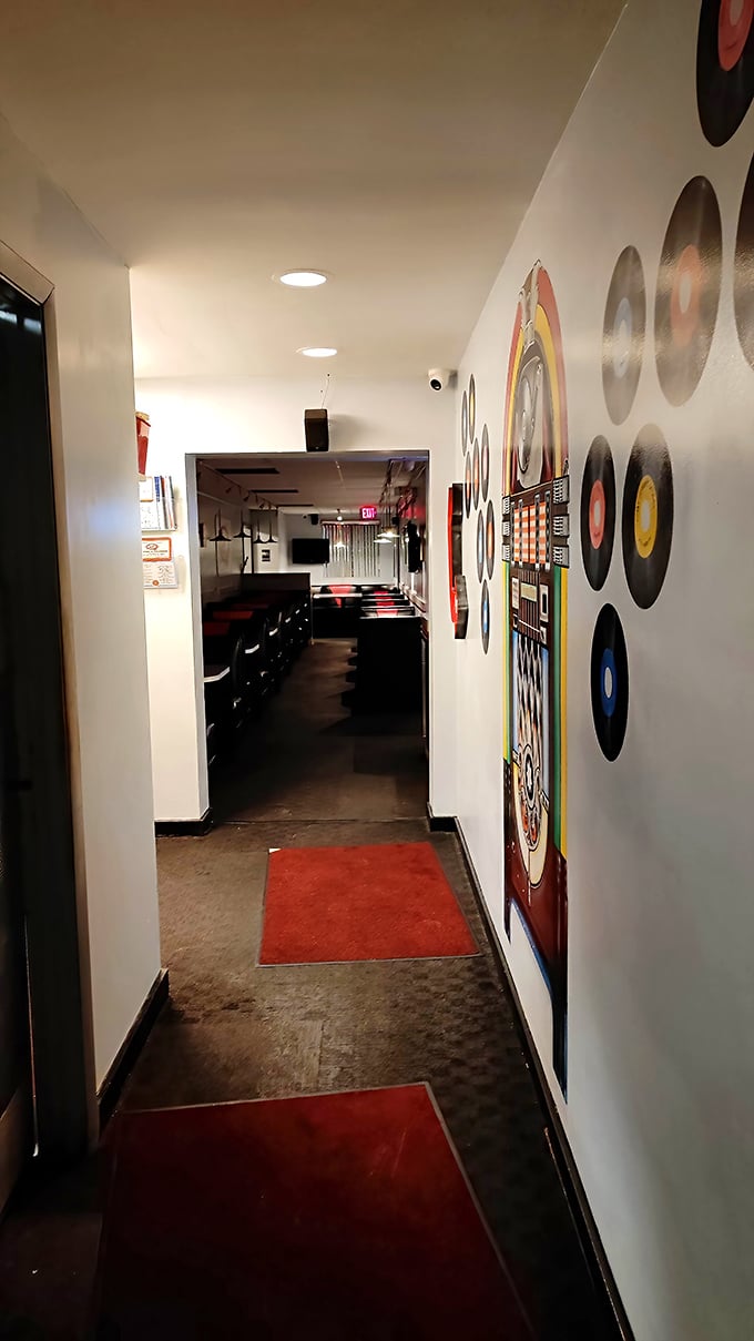 The hallway's vinyl record d&eacute;cor and classic diner aesthetic whisper promises of comfort food that's been perfected over decades, not designed for Instagram.