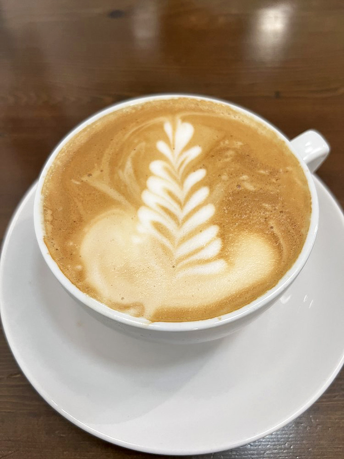 Latte art so pretty you almost don't want to drink it. Almost. That leaf design is practically begging for its Instagram moment.