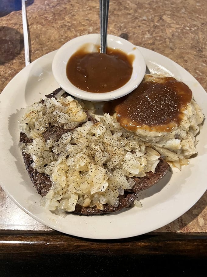 Country-style steak smothered in gravy with a side of perfectly seasoned home fries. The kind of plate that makes diets weep.