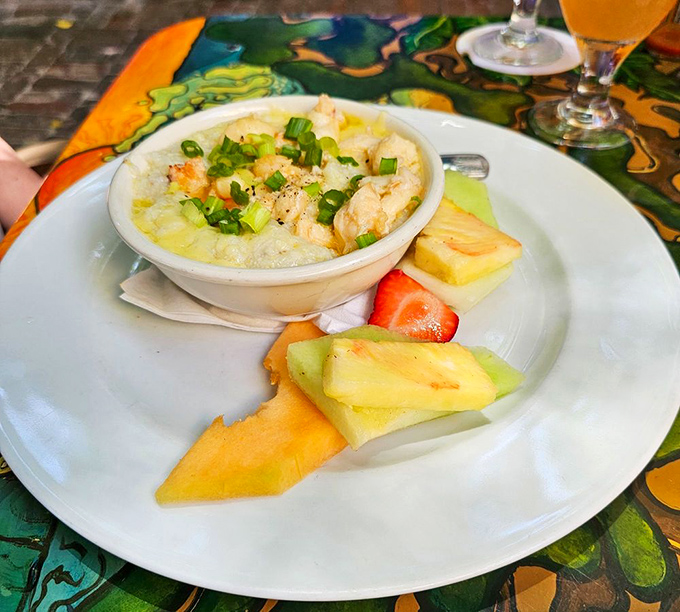 Shrimp and grits served with fresh fruit on the side&mdash;because in paradise, you can have your comfort food and eat healthy too.