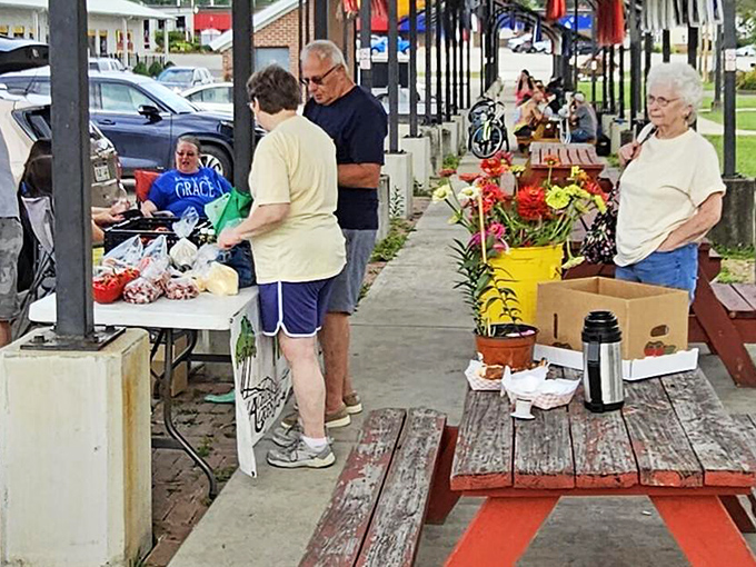 The farmers market&mdash;where conversations last longer than the shopping. These folks aren't just selling produce; they're maintaining a community tradition.