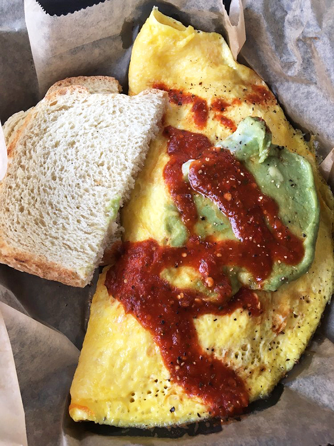 The perfect omelet doesn't exi— Oh wait, here it is, golden and fluffy with a side of toast that's just waiting for its moment.