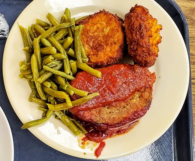 Meatloaf that would make your grandmother simultaneously proud and jealous, flanked by green beans that actually taste like vegetables.
