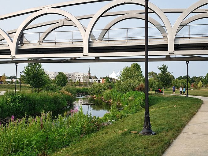 Meriden Green Park blends urban design with natural beauty, where modern bridges arch gracefully over restored waterways.