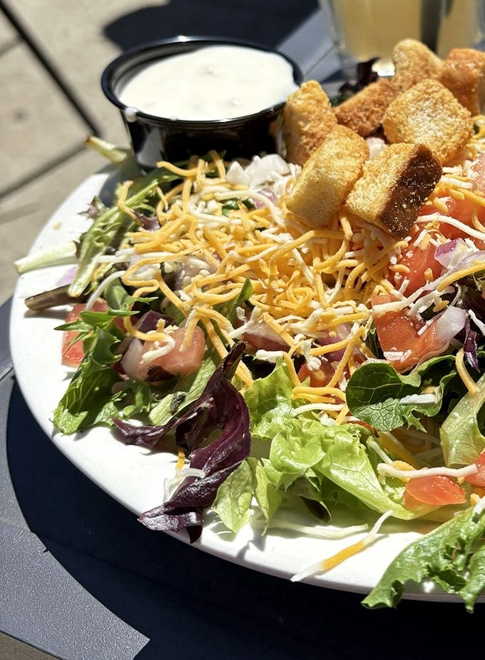 Even the house salad shows up dressed to impress, with shredded cheese standing at attention and croutons that actually deserve their place on the plate.
