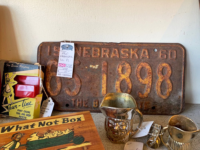 Rusty Nebraska license plates and vintage tins – the kind of Americana that makes you nostalgic for road trips you never took.