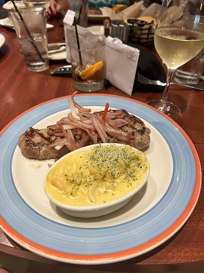 A perfectly cooked steak with a side that's practically glowing with cheesy goodness. This plate has serious main character energy.