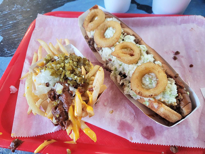 This masterpiece features onion rings riding atop a chili dog like delicious life preservers on a sea of flavor.