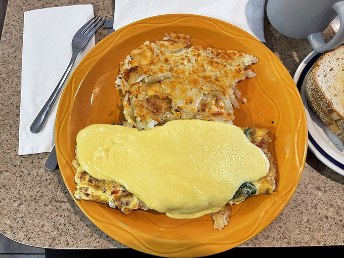 This cheese-draped omelet on its sunshine-yellow plate isn't just breakfast&mdash;it's edible optimism to fuel whatever the day might bring.