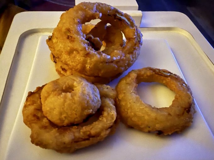 These aren't just onion rings; they're golden halos of happiness. Crispy, light, and perfectly engineered for maximum crunch-to-onion ratio.
