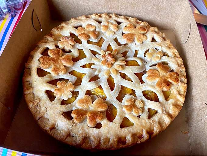 This isn't just a peach pie&mdash;it's edible art. The intricate lattice work suggests someone with the patience of a Renaissance sculptor works here.