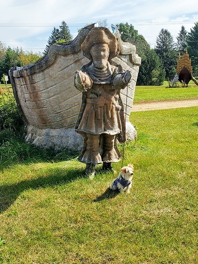 Ahoy, landlocked mateys! This weather-worn pirate stands guard with a faithful canine companion, proving sea dogs can find happiness in Wisconsin's grassy waves.