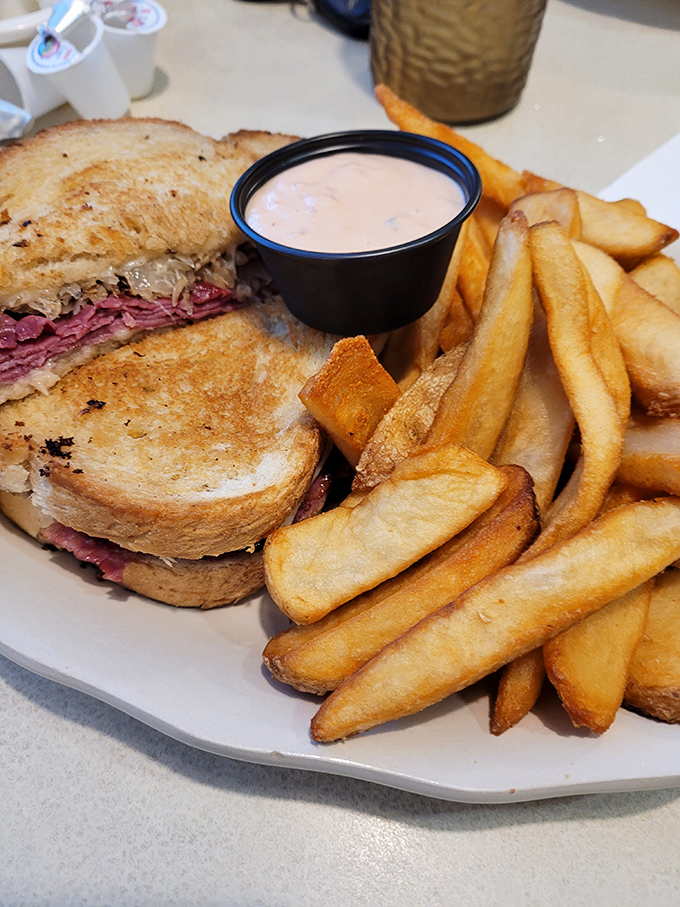 The Reuben that launched a thousand napkins. This glorious mess of toasted bread, tender meat, and melty cheese demands your full attention.