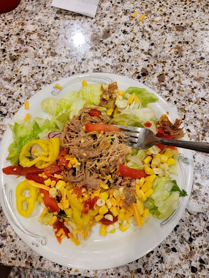 A colorful salad that proves healthy eating needn't be punishment—vibrant peppers and sweet corn playing supporting roles to perfectly seasoned pulled meat.