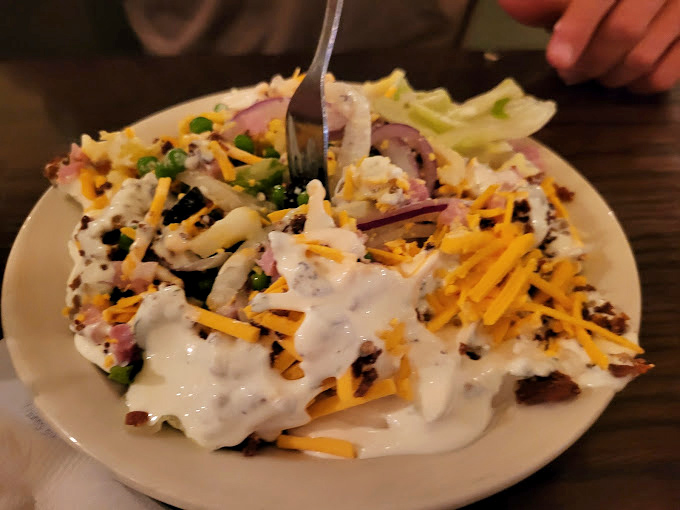 A salad that's having an identity crisis with more toppings than lettuce. This is how Midwesterners convince themselves they're eating healthy.