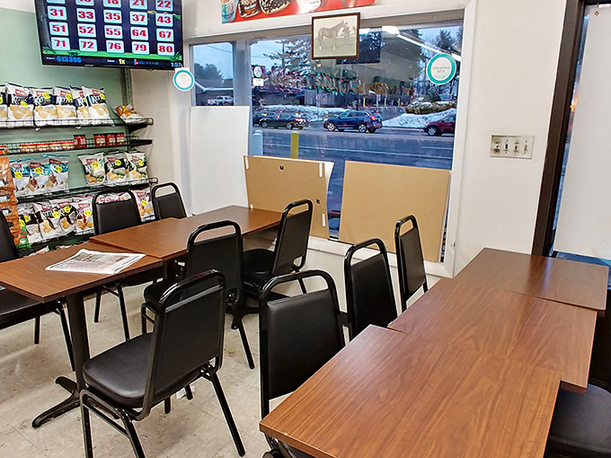 The modest dining area offers a front-row seat to Newark life passing by the windows, plus lottery dreams on the overhead screen.