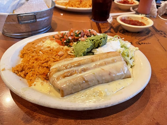 This chimichanga isn't just wrapped in a tortilla&mdash;it's wrapped in a blanket of queso that makes you want to send a thank-you note to whoever invented cheese.