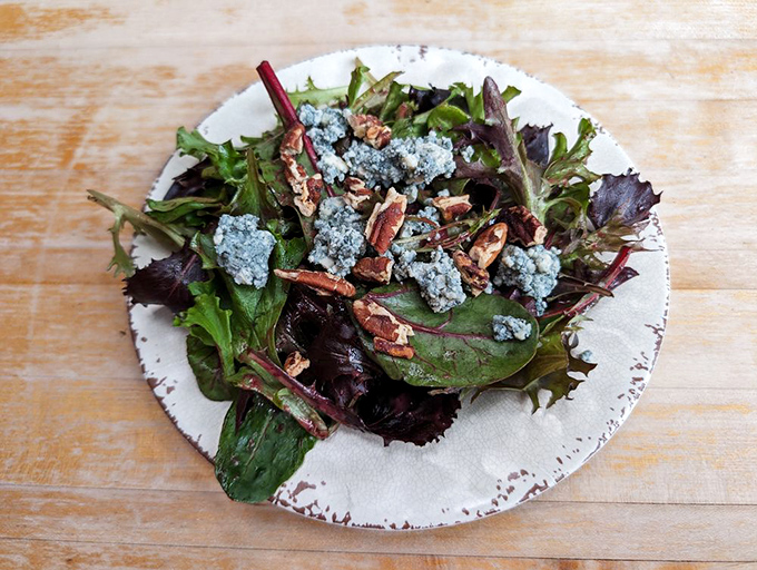 Even the side salad deserves attention here&mdash;fresh greens, blue cheese crumbles, and pecans create a symphony of textures and flavors.
