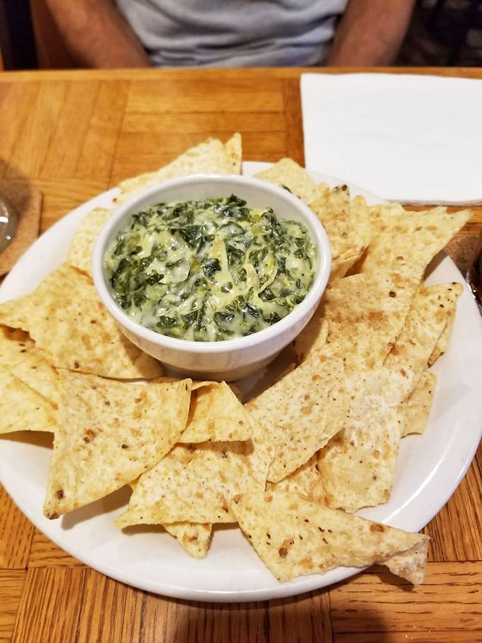 Spinach and artichoke dip that's traveled from 1990s fine dining to neighborhood favorite. The crispy chips are merely delivery vehicles for creamy goodness.