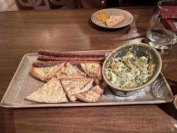 Spinach and crab dip that demands to be shared, yet inspires selfish thoughts. Those bread points and pretzel sticks? Tactical dipping instruments.