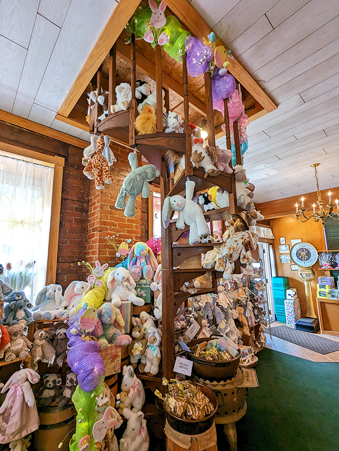 A spiral staircase of stuffed animals watches over the candy kingdom like plush guardians of a sugar-coated realm.