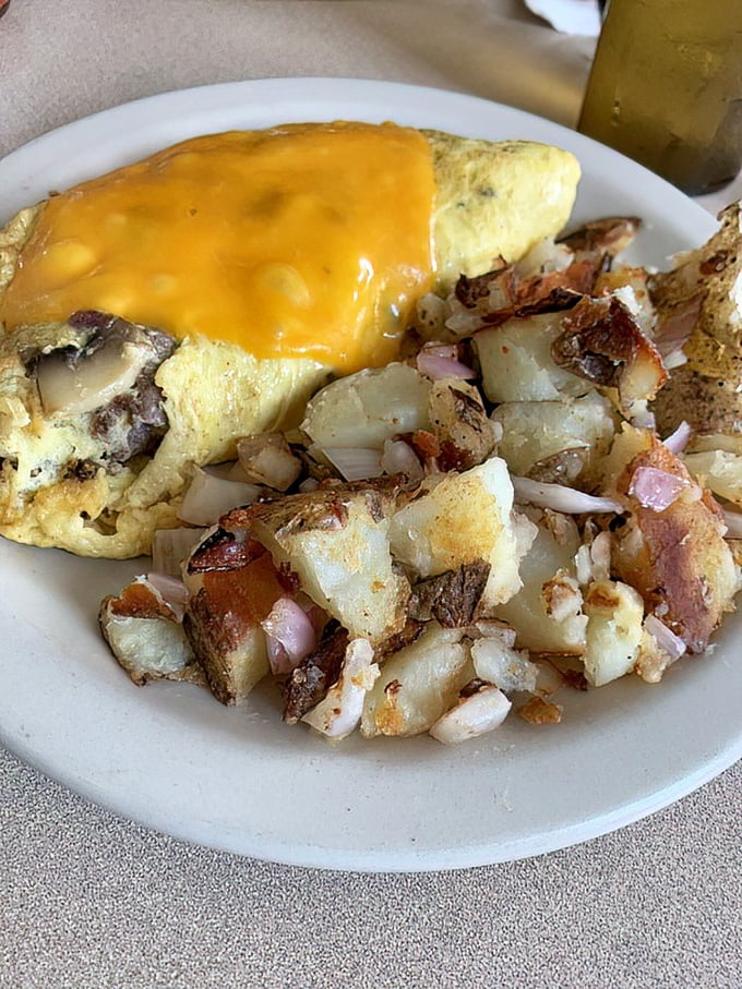An omelet that doesn't just contain cheese&mdash;it embraces it completely, with a side of potatoes that could make an Irishman weep with joy.
