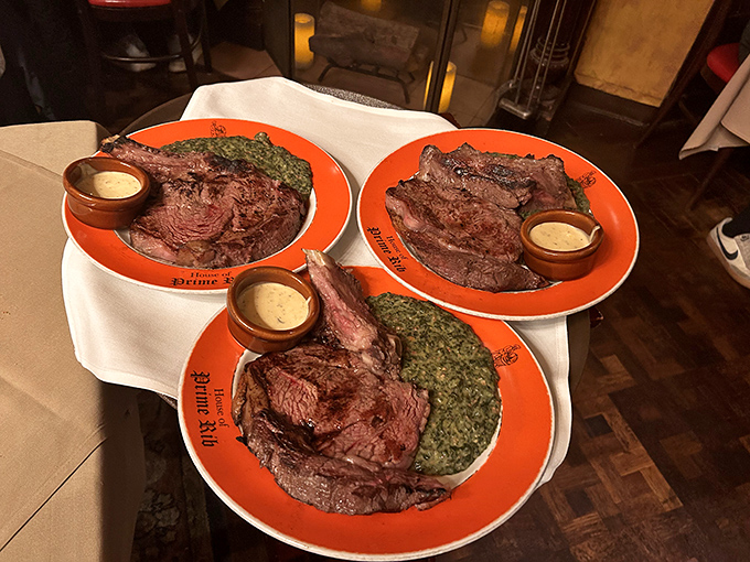 The holy trinity of prime rib plates, each sporting the restaurant's signature orange rim. One for you, one for me, one for later.