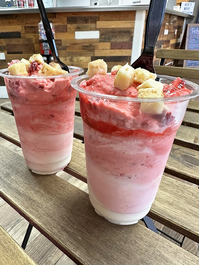 Strawberry cheesecake in custard form, topped with actual cheesecake pieces. It's like someone turned your grandmother's best dessert into a portable celebration.