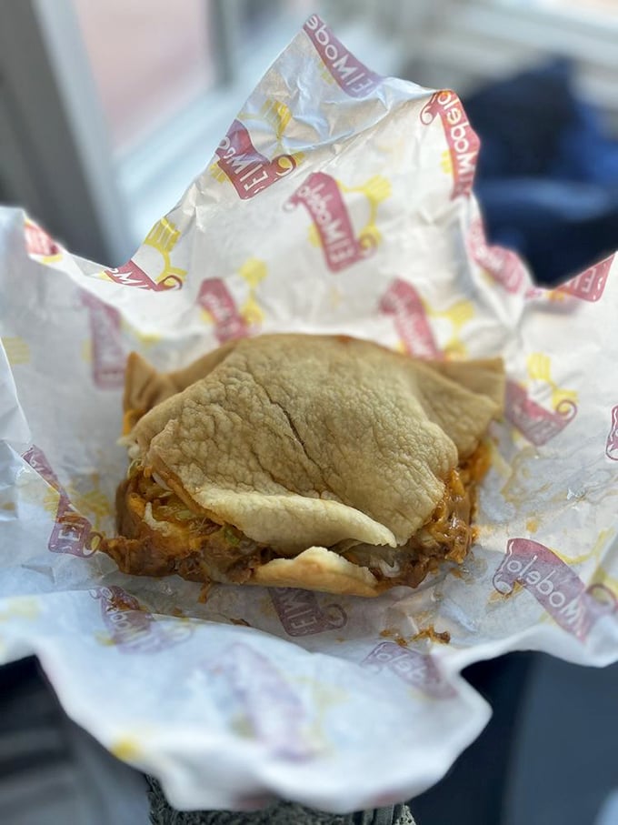 The stuffed sopaipilla sits like a golden pillow, cradling its savory filling while promising a sweet-meets-savory experience that defies description.