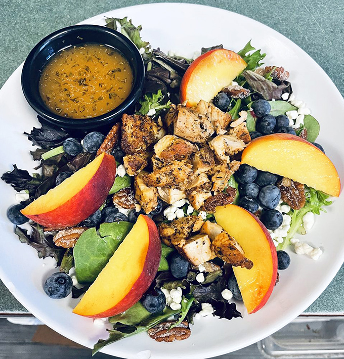 Summer on a plate: fresh peaches, blueberries, and grilled chicken atop mixed greens. A refreshing option for when you've had pancakes three days in a row.