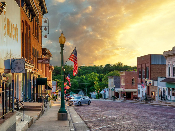 Golden hour in Mount Carroll transforms brick streets into ribbons of amber. Even the American flags seem to glow with extra patriotic fervor.