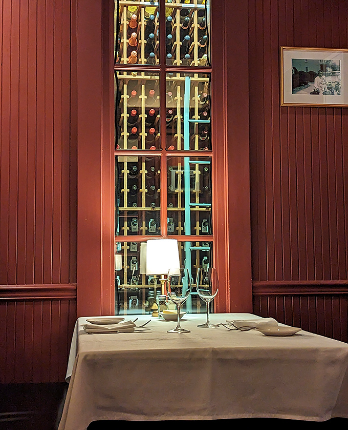 Behind this wall of bottles lies liquid poetry waiting to complement your steak in perfect harmony.