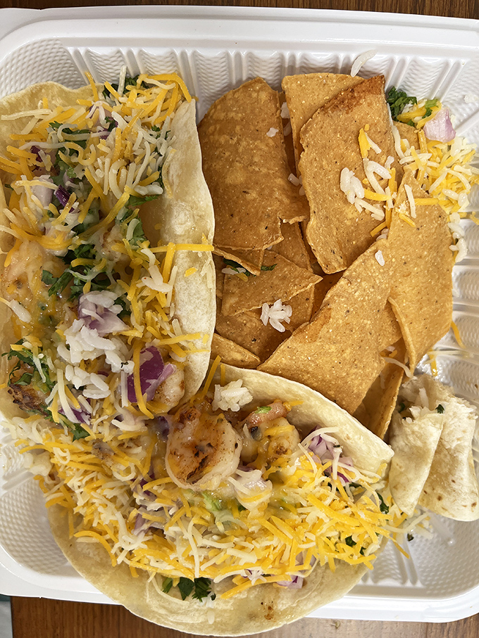 Taco Tuesday happens any day here. Cheese-sprinkled soft tacos nestled beside crispy chips—a combination that never fails to satisfy the soul.