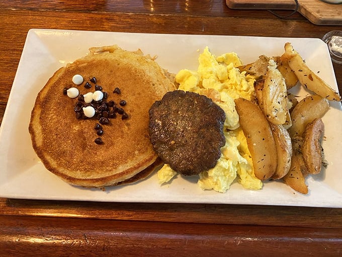 The breakfast trinity: golden pancakes, fluffy eggs, and seasoned potatoes. Add sausage and you've got a plate that could fuel a marathon&mdash;or a serious nap.