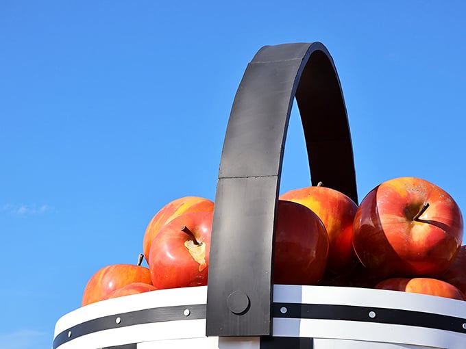 Those aren't small apples&mdash;that's a massive handle! The basket's crown jewel arches dramatically against the sky like a wooden rainbow.