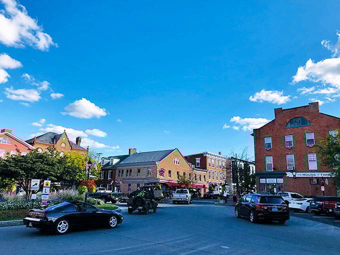 Downtown Gettysburg buzzes with life as modern vehicles navigate historic streets. History and contemporary life coexist in perfect, bustling harmony.