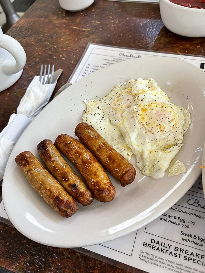 Sausage links with that satisfying snap and eggs with just enough pepper to remind you that someone in the kitchen actually cares.
