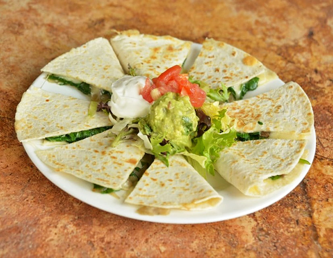 Vegetarian quesadillas that prove meatless doesn't mean joyless&mdash;crispy tortillas revealing their spinachy secrets with each delectable triangle.