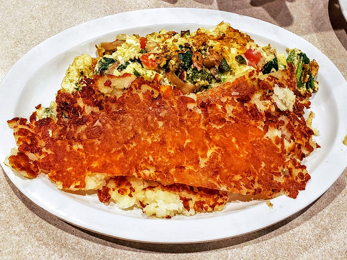 This veggie omelet with crispy hash browns is breakfast architecture at its finest&mdash;a savory skyscraper of morning deliciousness.