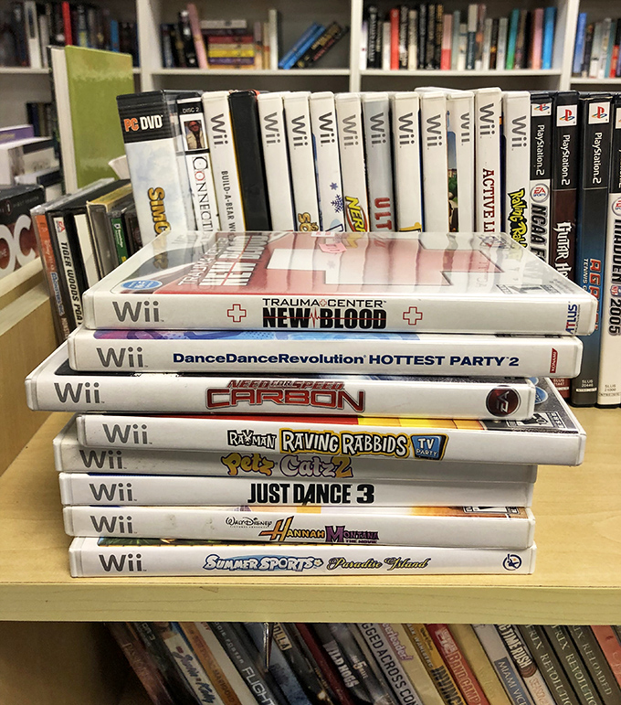 A stack of Wii games that tells the story of family game nights, abandoned fitness resolutions, and the brief reign of motion-controlled entertainment.