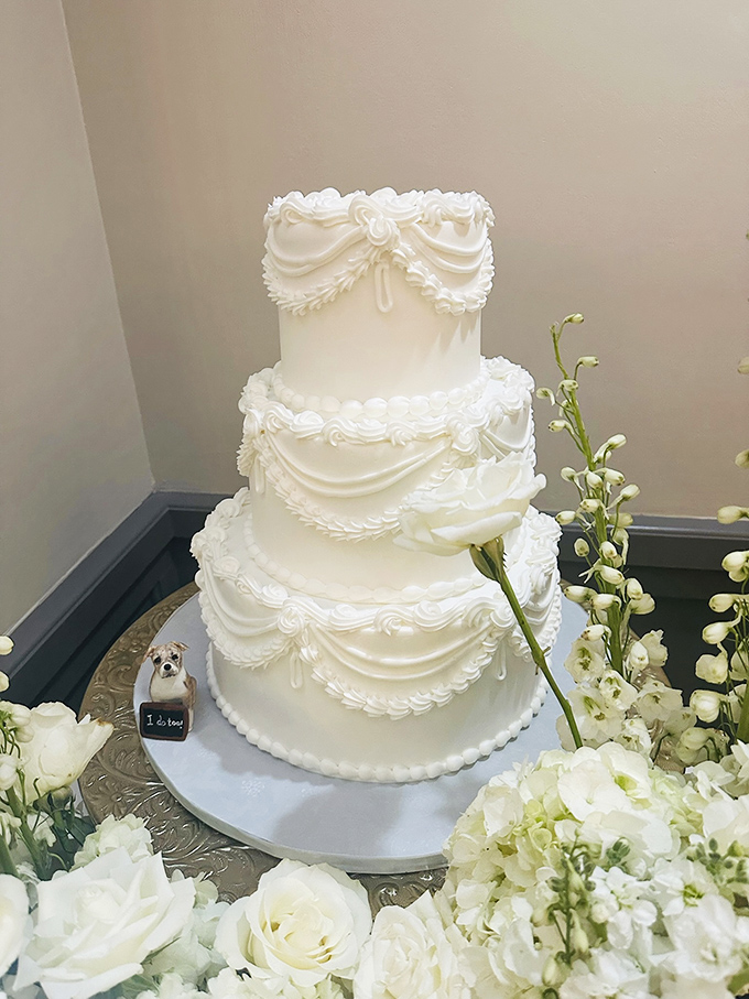 A wedding cake so elegant it could make a commitment-phobe reconsider their life choices. Those buttercream swags are pure artistry.
