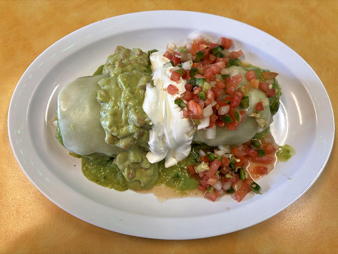 Not all heroes wear capes—some wear sour cream drizzles. This plated masterpiece combines the comfort of a burrito with the indulgence of enchilada-style presentation.